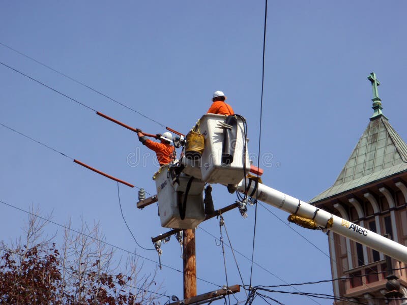 Men from a Crane on a Utility Pole Working on a Power Line Editorial ...