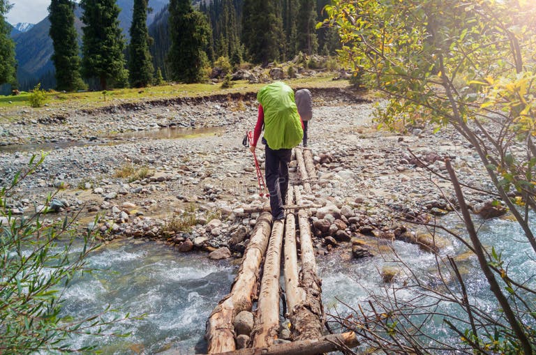Men Crossing Bridge Over the River Stock Image - Image of bridge ...