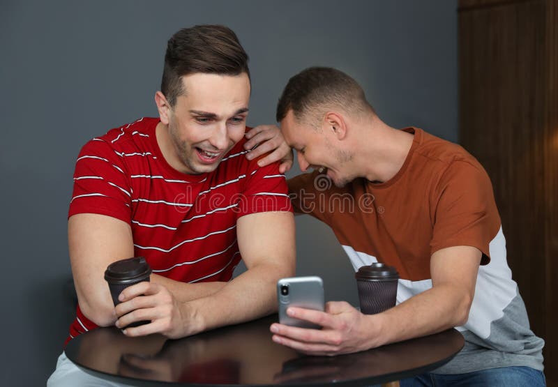Men with Cups of Coffee and Smartphone Laughing Together Stock Image ...