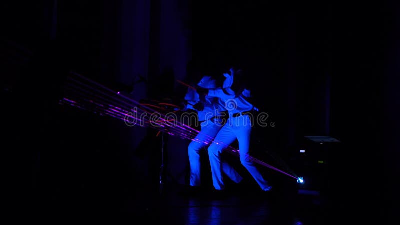 Laser Led Dance Show. a Group of Dancers in Glowing Costumes Dance ...