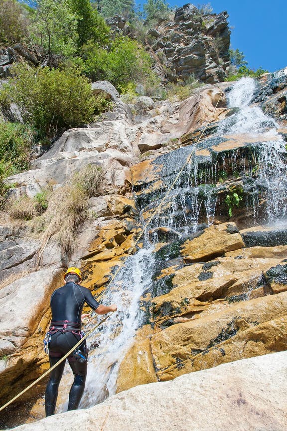 Men descending waterfall stock photo. Image of nature - 21609320