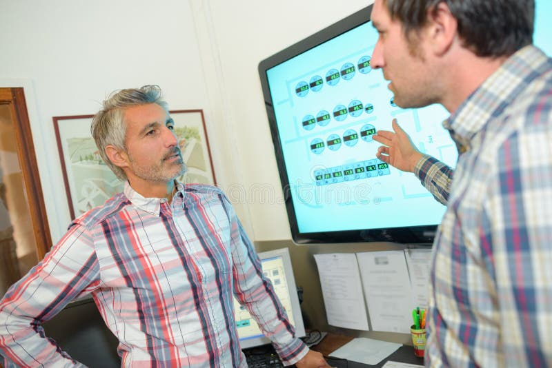 Men Discussing Display on Computer Screen Stock Photo - Image of screen ...