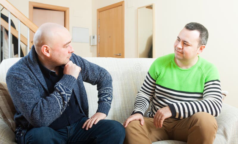 Men discussing at home stock image. Image of friendship - 45773553
