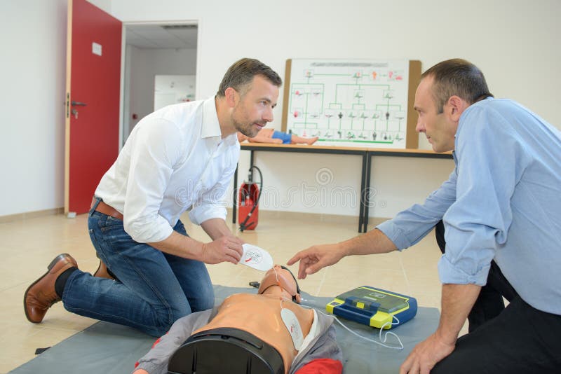 Men Doing First Aid with Dummy Stock Photo - Image of rescuer ...