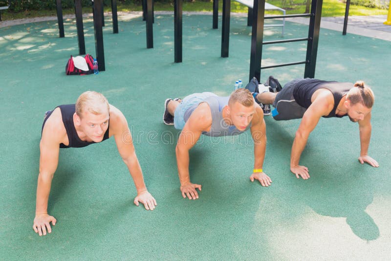 Men doing push-ups stock image. Image of outside, trainer - 92506035