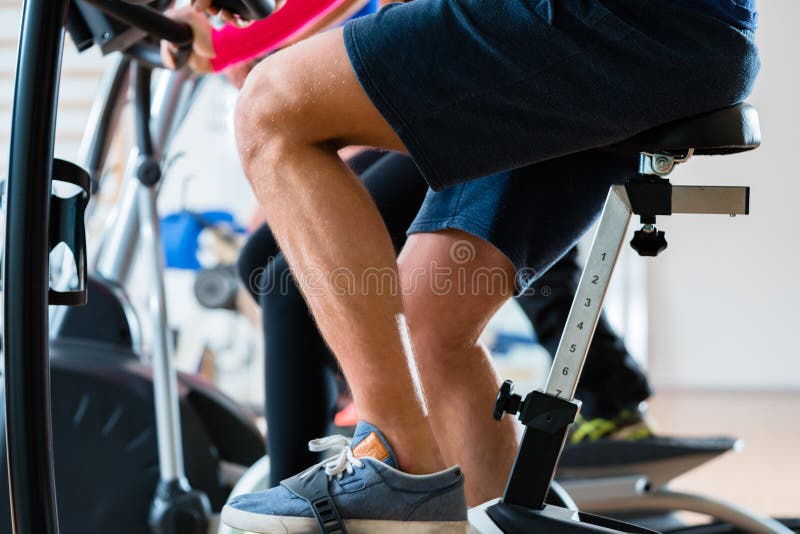 Men Doing Workout on Exercise Bike at Gym Stock Image - Image of ...