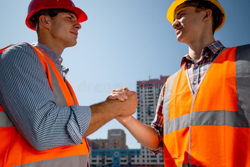 Construction Workers Wearing Safety Clothing Worker on Building Site ...