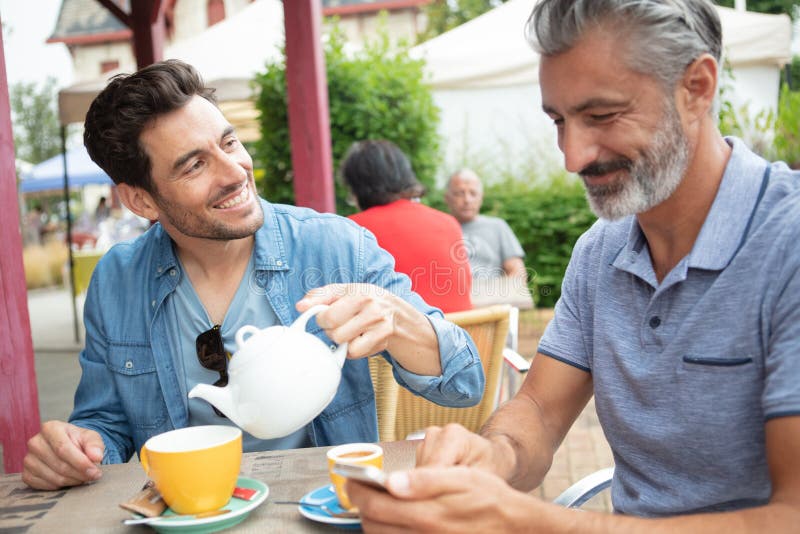 2 Men Drinking Tea Outdoors Stock Photo - Image of wooden, detail ...
