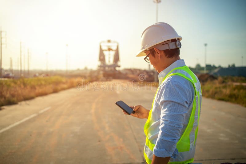 Men Engineer Using Mobile Phone and Holding Tablet for Inspecting and ...