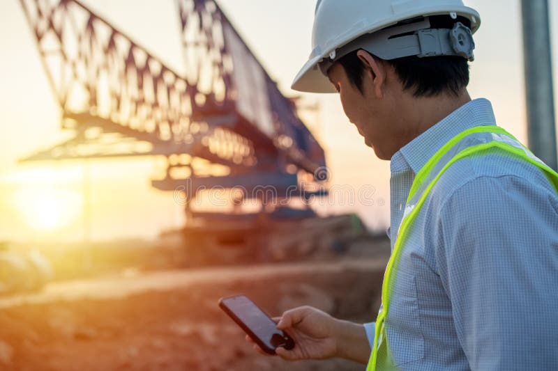 Men Engineer Using Mobile Phone and Holding Tablet for Inspecting and ...