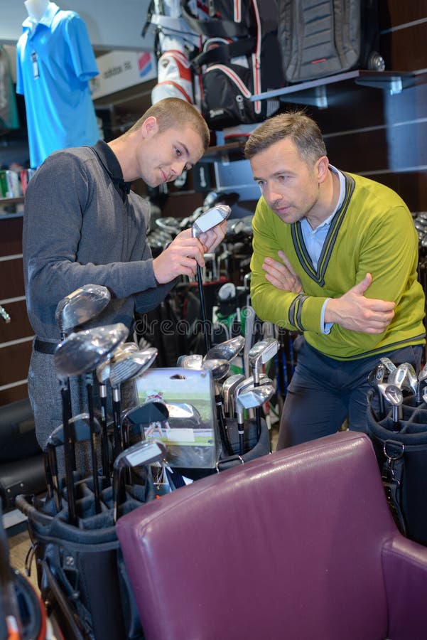 Men Examining Golf Clubs in Store Stock Image - Image of inspect, sport ...