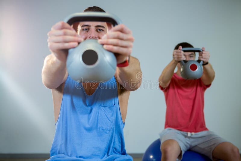 Men Exercising on Exercise Ball Stock Photo - Image of people ...