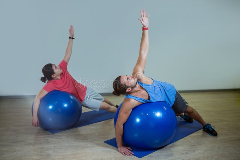 Men Exercising with Exercise Ball Stock Image - Image of people, floor ...
