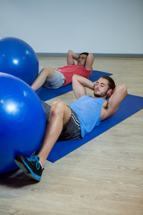 Men Exercising on Exercise Mat Editorial Image - Image of endurance ...
