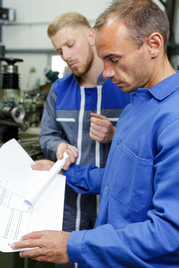Men in Factory Looking at Paperwork Stock Image - Image of partnership ...
