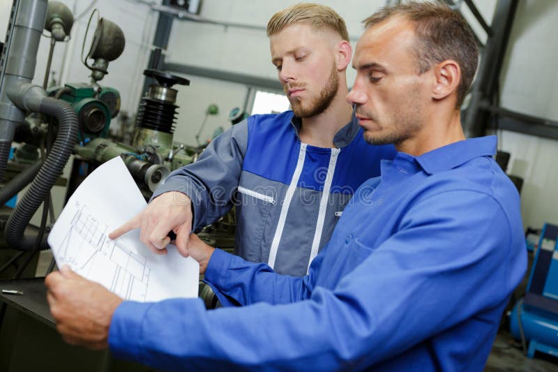Men in Factory Looking at Paperwork Stock Photo - Image of senior ...