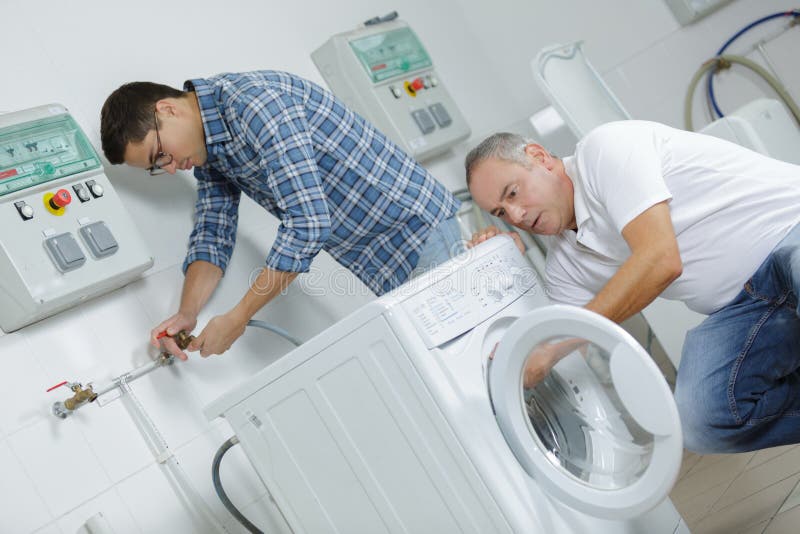 Men Fitting Washing Machine Stock Photo - Image of open, worker: 248309820