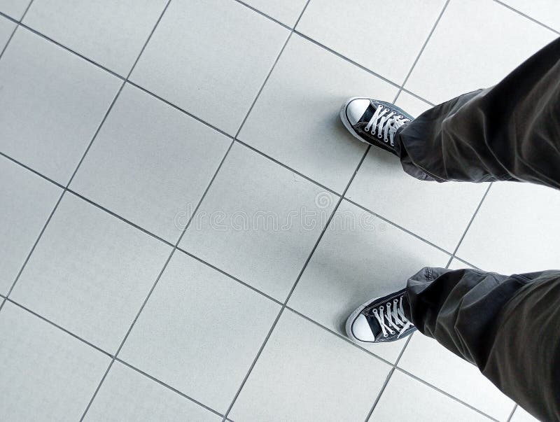 Men foot on tile floor stock image. Image of footwear - 276284025