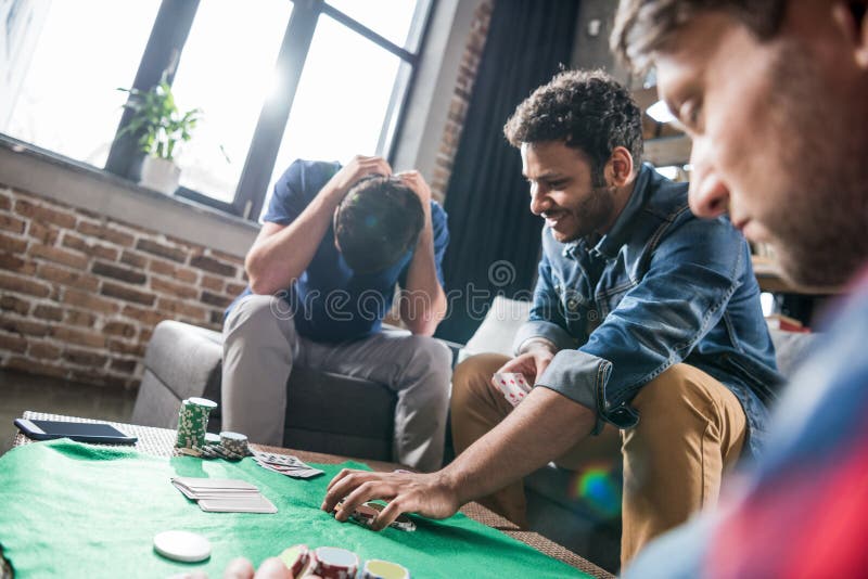 Men at gaming table stock image. Image of multiethnic - 93100289