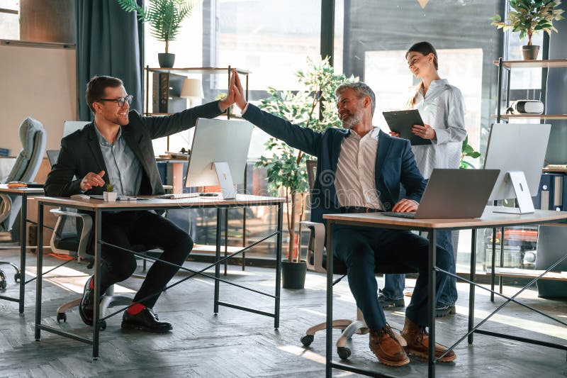 Men are Giving High Five. Group of Business People are Working in the ...
