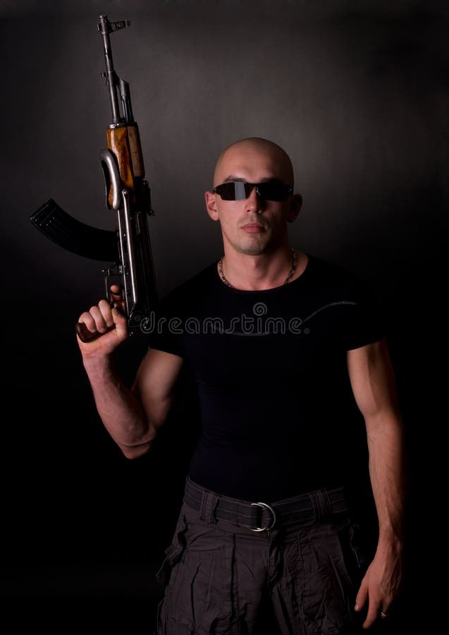 Serious Male Holding a Gun stock photo. Image of murderer - 35762824