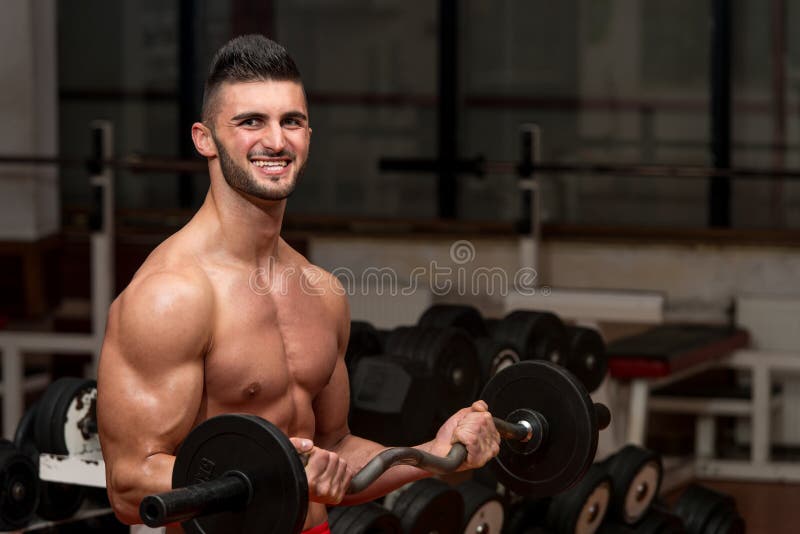 Men in the Gym Performing Biceps Curls with a Barbell Stock Image ...