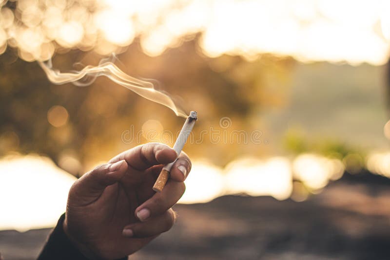Men Hand Caught a Burning Cigarette Causing Smoke, Concept Stop Smoking ...