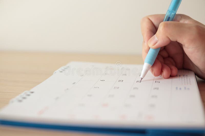 Hand with Pen Writing on Calendar Date Stock Image - Image of paper ...