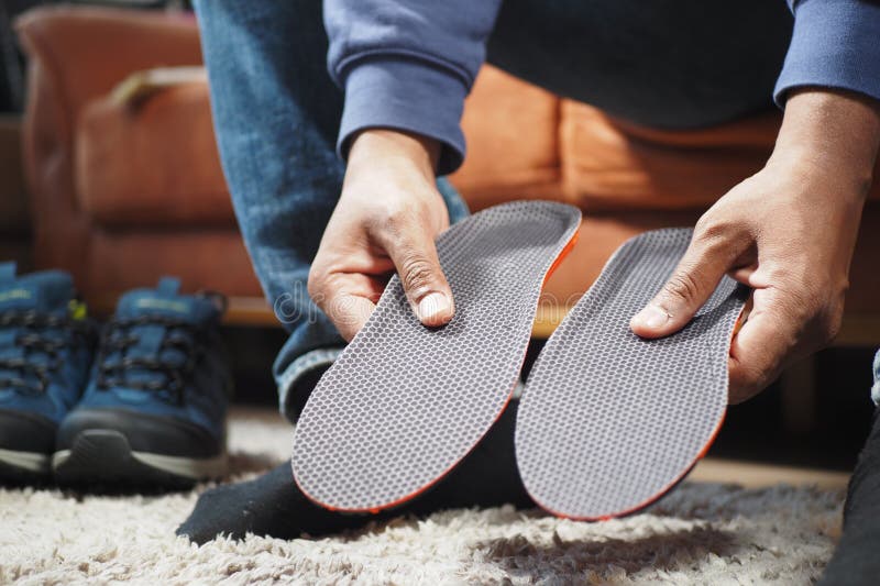 Men Hand Putting Orthopedic Insoles in Shoes Stock Photo - Image of ...