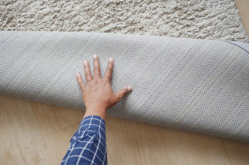 Men Hand Rolling Out New Rug. Stock Photo - Image of gentle, indoors ...