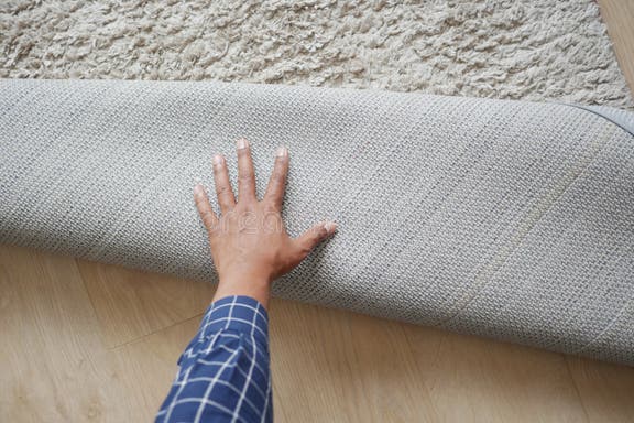 Men Hand Rolling Out New Rug. Stock Photo - Image of gentle, indoors ...