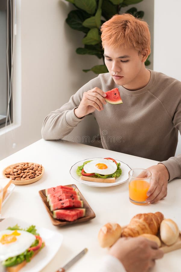 Men Having Breakfast with Toasts at Table Stock Photo - Image of ...