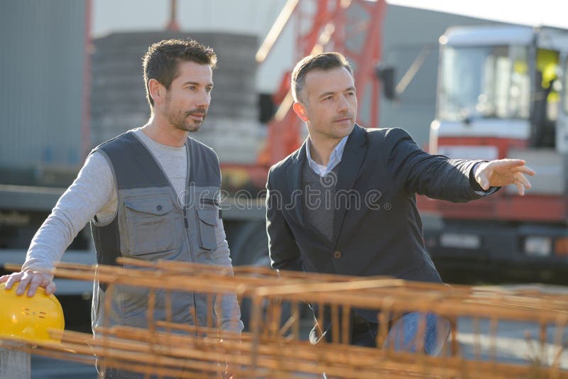 Men Having Conversation on Construction Site Stock Image - Image of ...