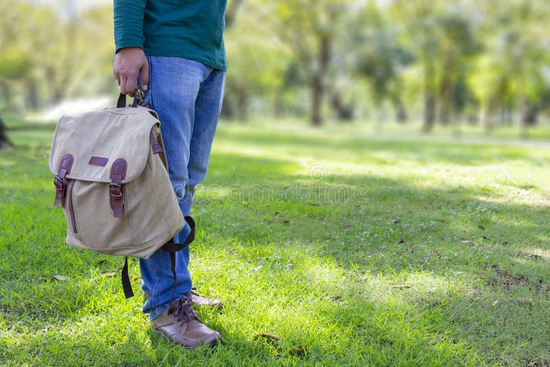 The Men Hold the Backpack Made with Canvas Standing on a Bright Stock ...