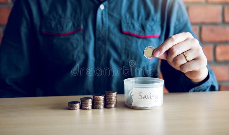 Men are Holding Coins Dropping To the Money Box with the Concept of ...