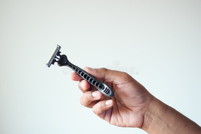 Men Holding a Razor Against White Wall Stock Photo - Image of equipment ...