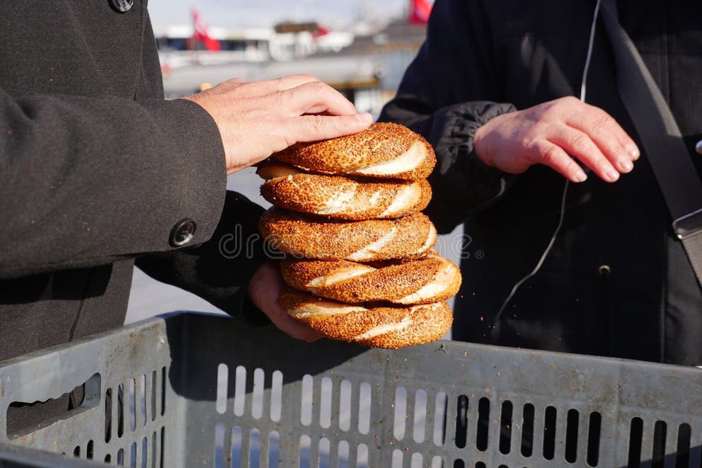 Men Holding Stack of Turkish Bagel Simit Stock Image - Image of glass ...