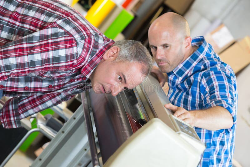 Men Inspecting Billboard Machine Stock Image - Image of workshop, model ...