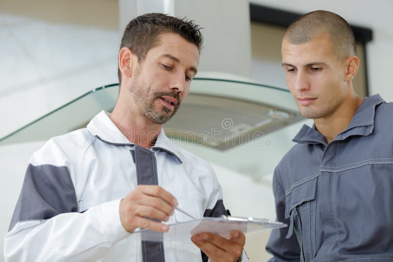 Men Installing New Induction Hob in Modern Kitchen Stock Photo - Image ...
