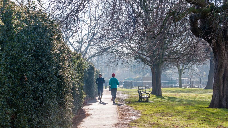 Men Jogging in a Park in a Sunny Cold Frosty Day Editorial Image ...