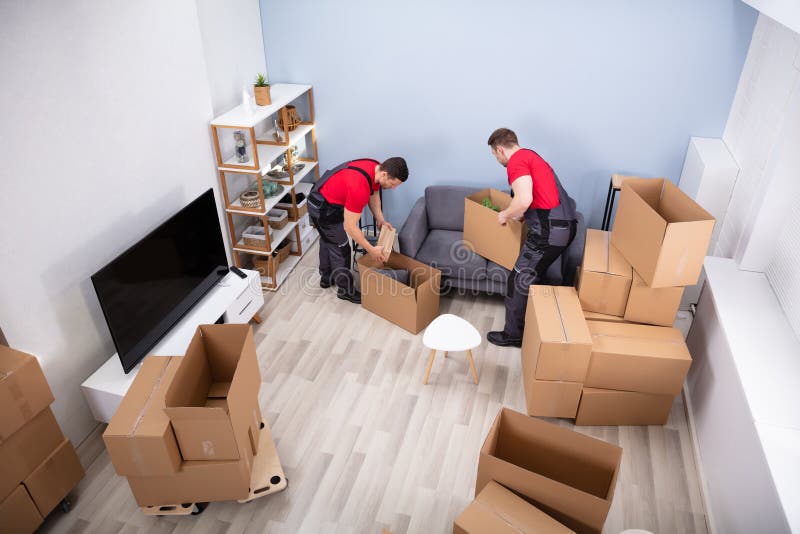 Men Loading the Cardboard Boxes during Moving Stock Image - Image of ...