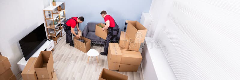Men Loading the Cardboard Boxes during Moving Stock Image - Image of ...