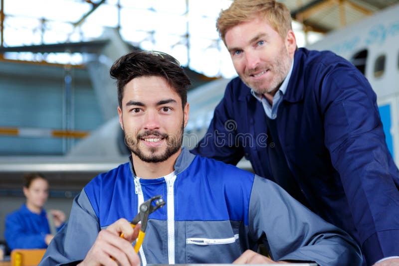 Men Looking at Camera in Workshop Stock Photo - Image of person ...