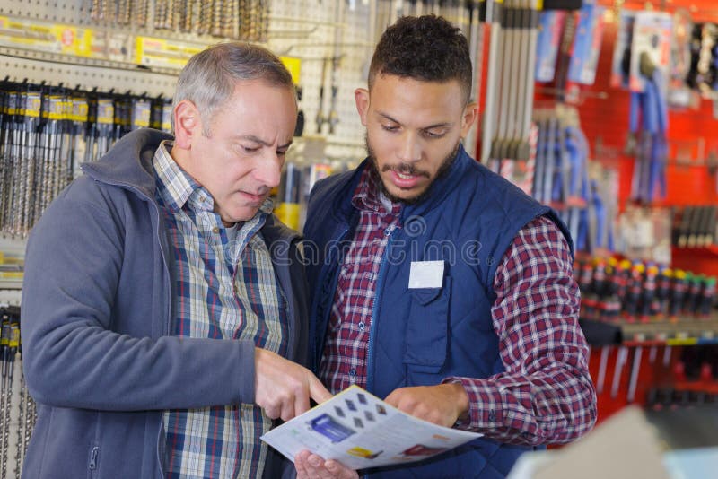 Men Looking at Catalogue in Tools Shop Stock Image - Image of plaid ...