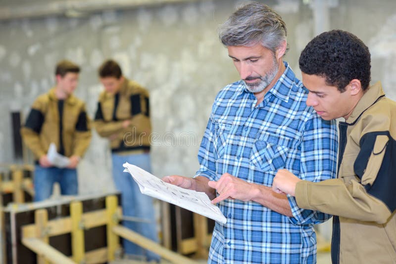 Men looking at design stock image. Image of teen, teach - 83782153