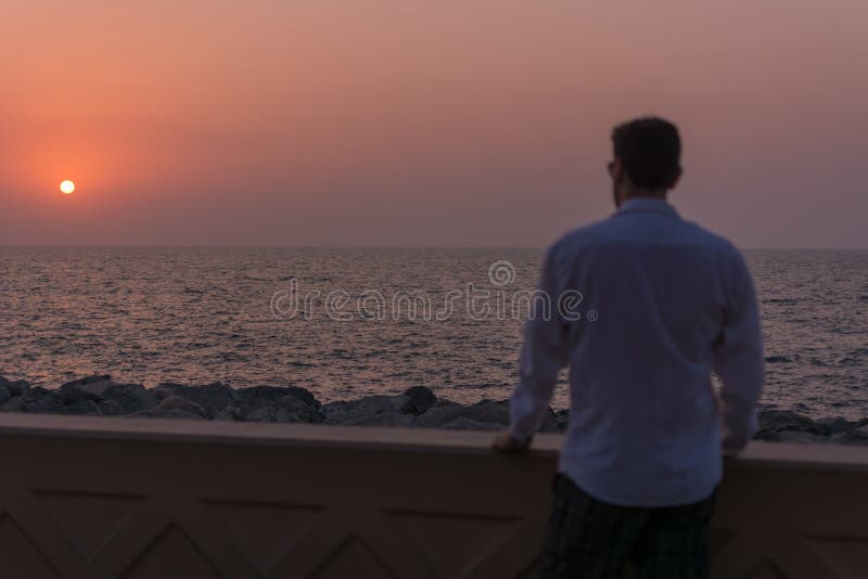 Men looking at sunset stock image. Image of person, beach - 38816711