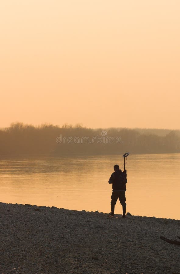 Men with Metal Detector in Sunset Stock Photo - Image of sunset ...