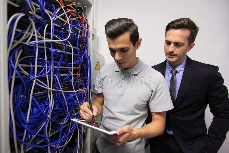 Men in network server room stock photo. Image of engineer - 77139904