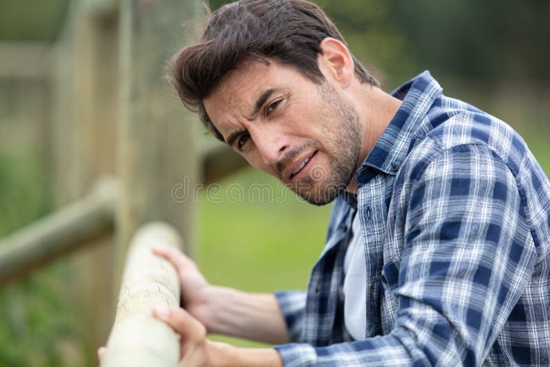 Men Observing from Rustic Wood Fence Stock Photo - Image of maintenance ...