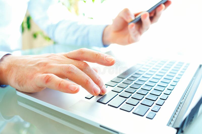 Men Office Worker Typing on the Keyboard and Using Smartphone Stock ...